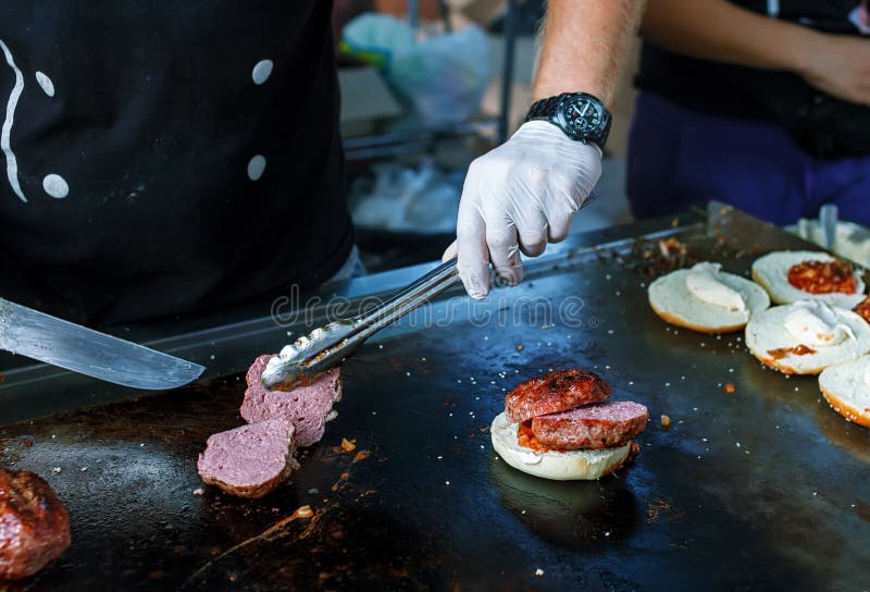 Chef Preparing Burgers at the Barbecue Outdoors Stock Photo - Image of ...