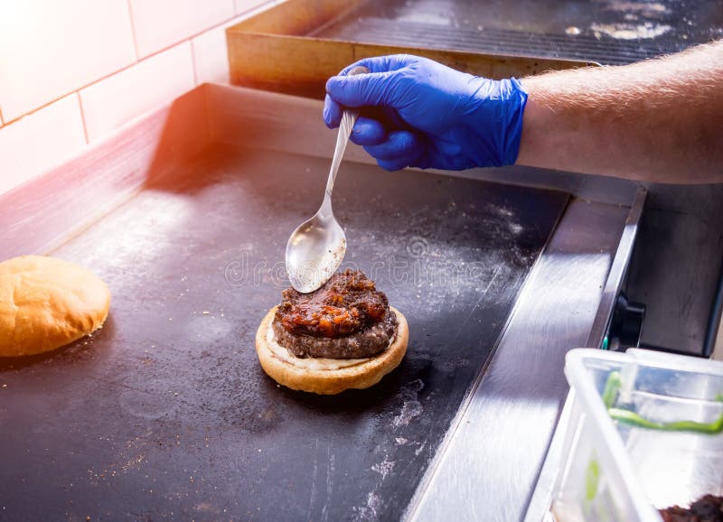Chef Preparing Burgers at the Kitchen Grill Stove. Restaurant Stock ...
