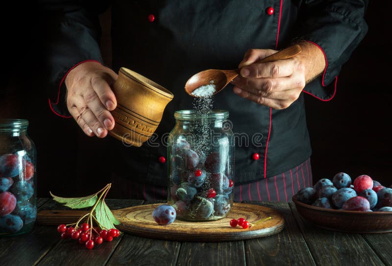Chef Preparing or Canning Plums with Sugar in a Jar. Working ...