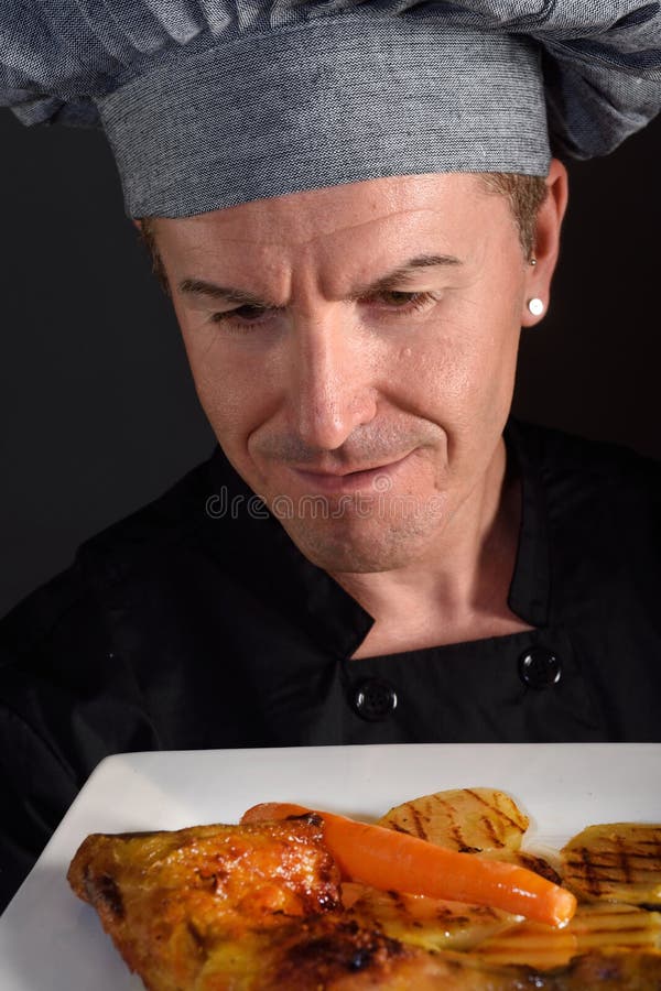 Chef Preparing a Chicken Dish with Garnish Stock Photo - Image of ...