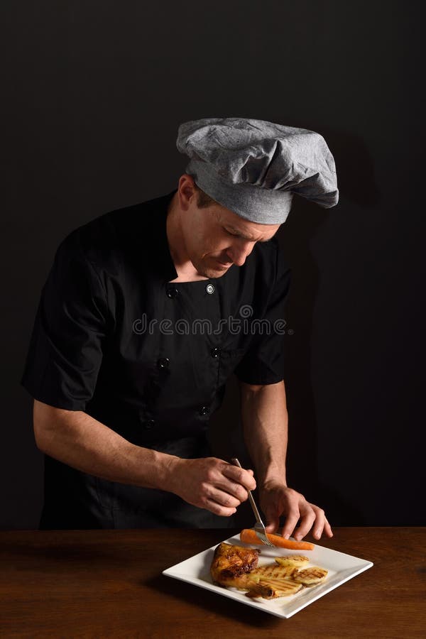Chef Preparing a Chicken Dish with Garnish Stock Photo - Image of ...