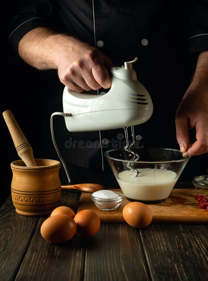 Chef is Preparing a Culinary Dish in the Kitchen with Milk and Eggs ...