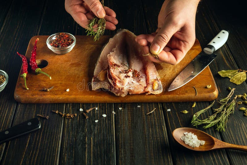The Chef is Preparing Fish on the Kitchen Board for Lunch. Adding ...