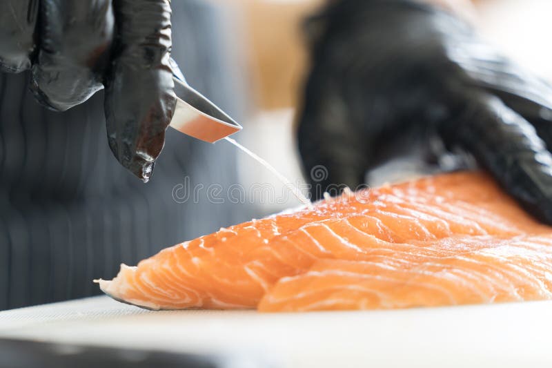 Chef Preparing a Fresh Salmon Fillet in Japanese Kitchen. Close Up Hand ...