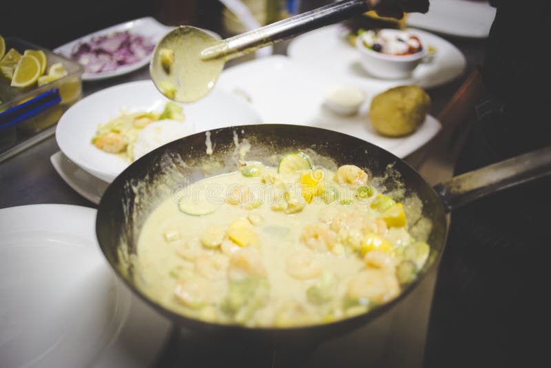 Chef Preparing a Gourmet Dish in a Rustic Restaurant Kitchen Stock ...