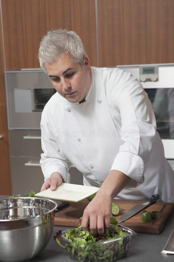 Chef Preparing Salad in Commercial Kitchen Stock Photo - Image of knife ...