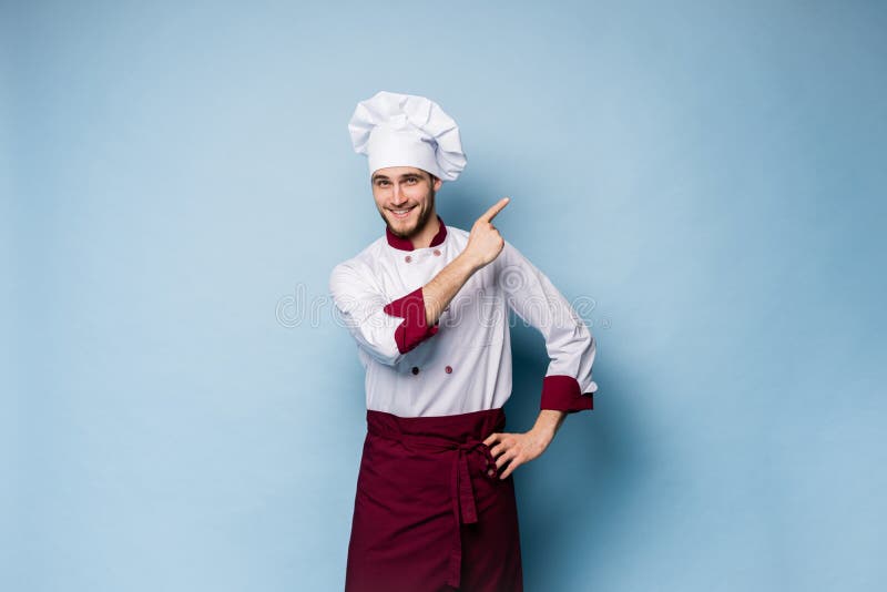Chef Presenting Something Over Light Blue Background Stock Photo ...