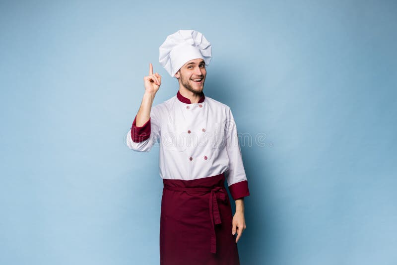 Chef Presenting Something Over Light Blue Background Stock Photo ...