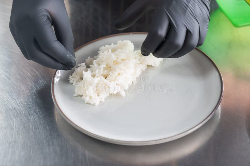 The Chef Puts Boiled Rice on a Plate. Stock Image - Image of kitchen ...