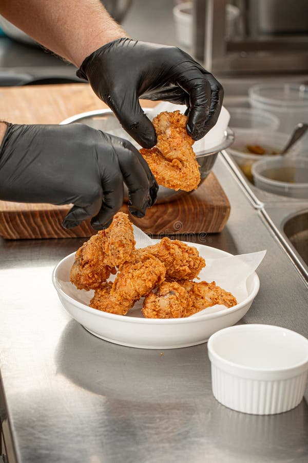 Chef Puts the Fried Chicken Wings on a Plate Stock Photo - Image of ...