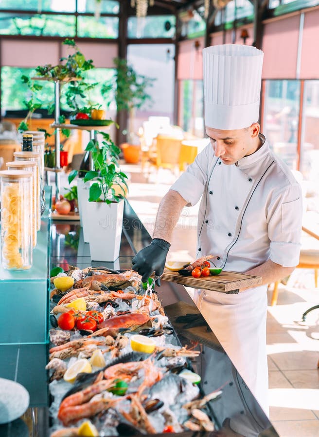 The Chef Puts the Seafood on a Tray in the Restaurant. Stock Photo ...