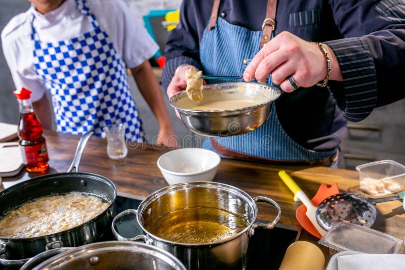 Chef Puts the Slices of Fish with Batter in the Pan with Butter. Master ...