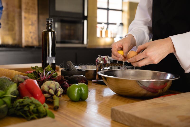 Chef Breaking Eggs into Flour Stock Image - Image of making, holding ...