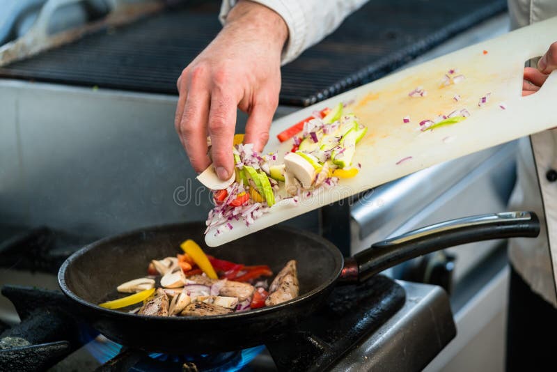 Chef Putting Ingredients To Pan in Restaurant Kitchen Stock Photo ...