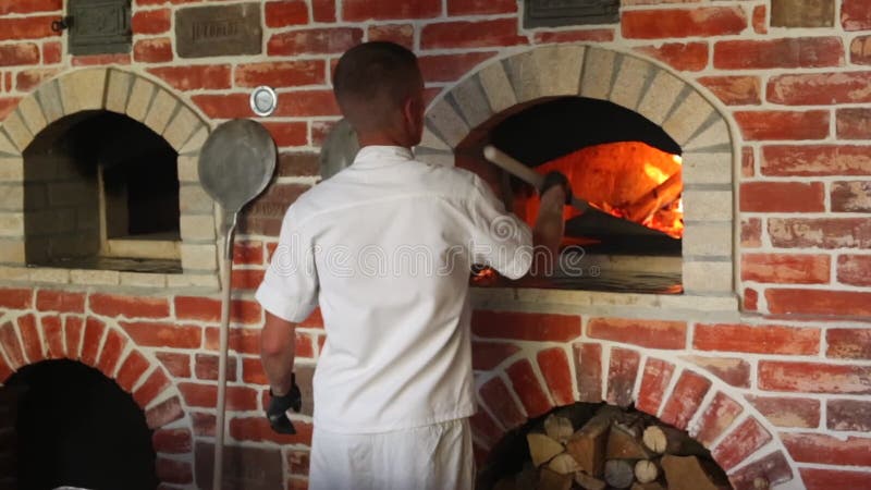 Man Putting Pizza in the Fired Oven Stock Video - Video of goggles ...