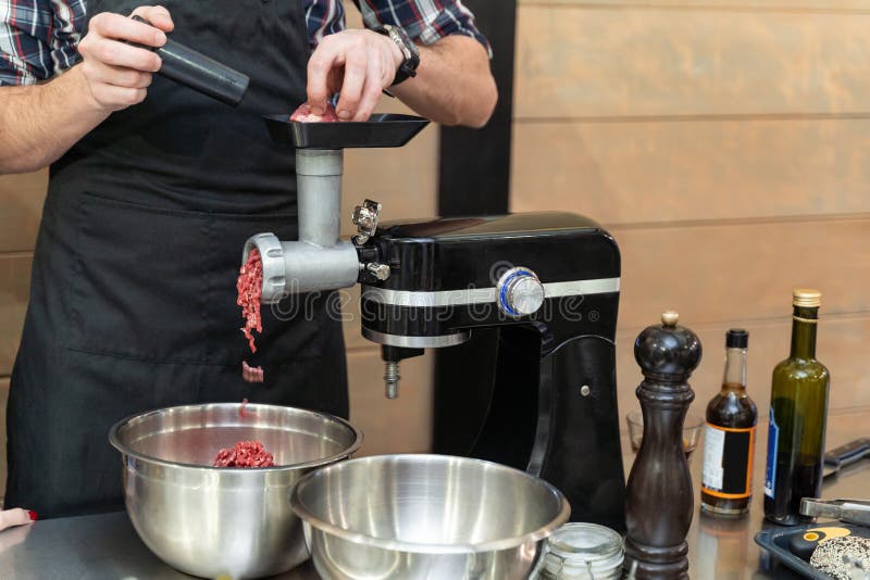 Chef Putting Raw Meat into an Electric Grinder Stock Photo - Image of ...