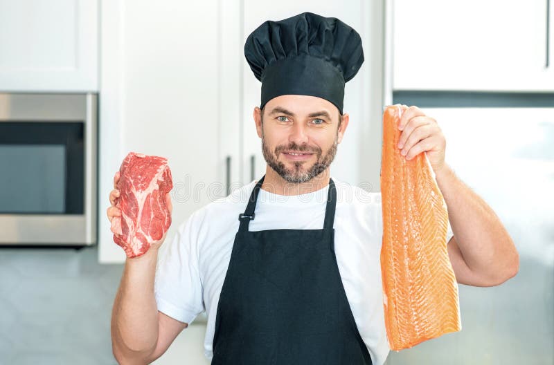 Chef with Raw Meat Beef and Fish Salmon Fillet on Kitchen. Chef Man in ...
