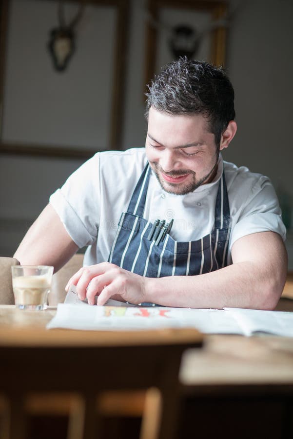 Chef reading a newspaper stock photo. Image of business - 76153452