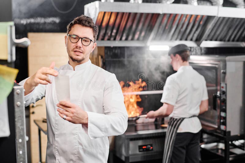 Chef Reading Order for His Staff Stock Image - Image of dinner, oven ...