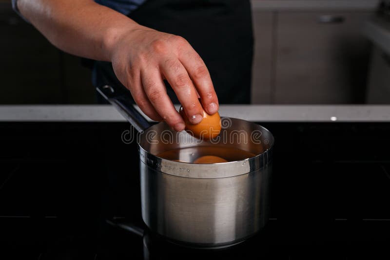 Chef Removing an Egg from Water Stock Photo - Image of dinner, book ...