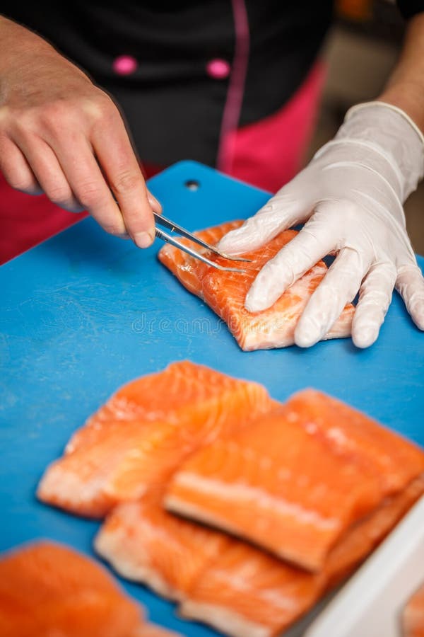 Chef removing fish bone stock photo. Image of taking - 88894604