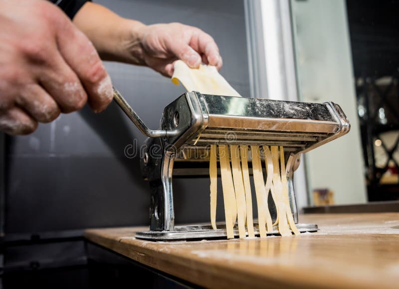 Chef Rolling Dough with a Pasta Machine. Pasta Maker Machine Stock ...