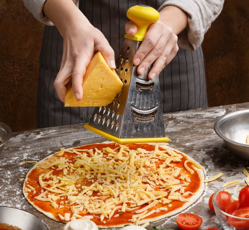 Chef Rubbing Cheese on Grater at Pizzeria Kitchen Stock Photo - Image ...