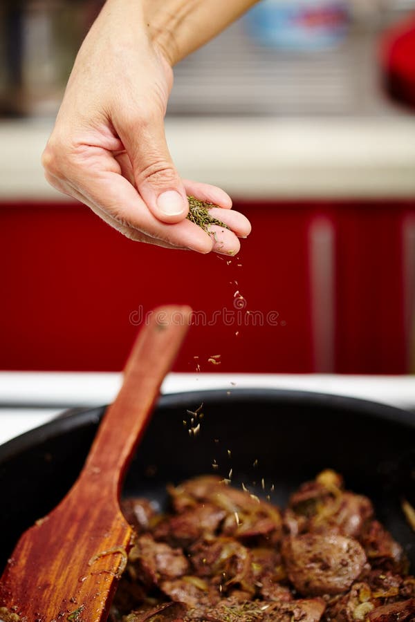 Cook S Hand Sprinkling Parsley and Basil in the Sauce Pan Stock Photo ...