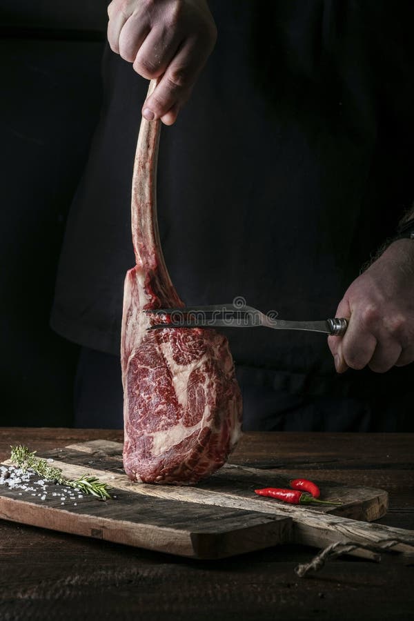 The Chef`s Hands Hold a Raw Tomahawk a Beef Steak Stock Photo - Image ...
