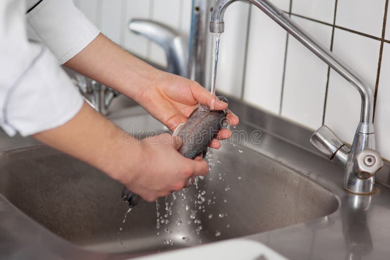 Washing Of Fish Fillets In Salt Water. Fresh Raw Codfish Steak In ...