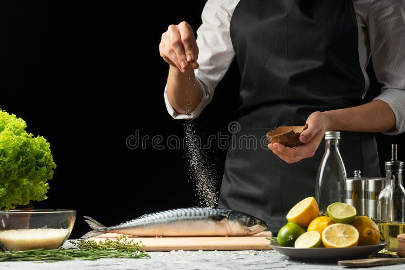 Cooking the Chief of Fresh Fish, the Chef Salt Fish on a Black ...
