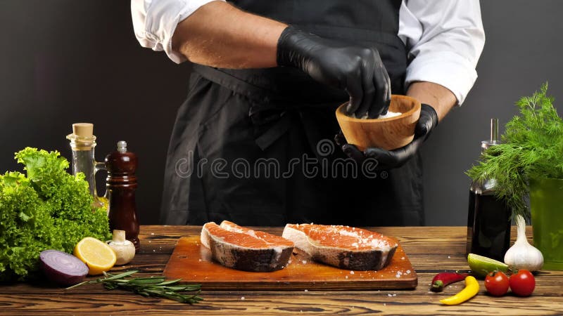 Chef Salting Salmon Steaks on a Wooden Table Stock Video - Video of ...