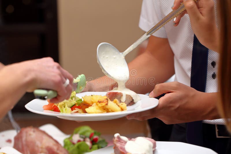 Chef Serves Portions of Food at a Party Stock Photo - Image of garlic ...
