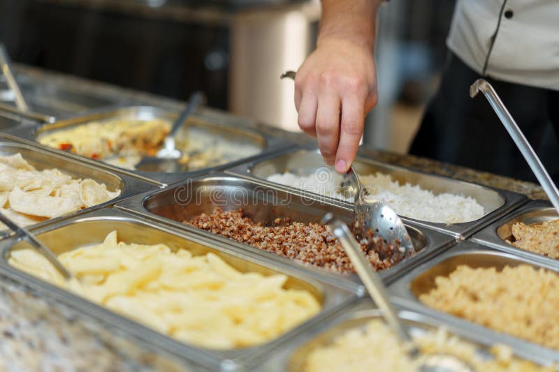 Chef Serving Freshly Cooked Dishes at a Restaurant Buffet during ...