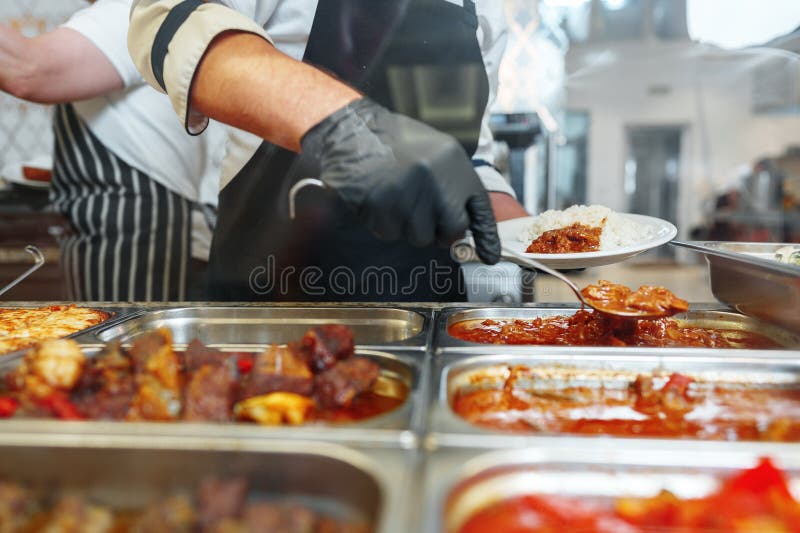 Chef Serving Freshly Cooked Dishes at a Restaurant Buffet during ...