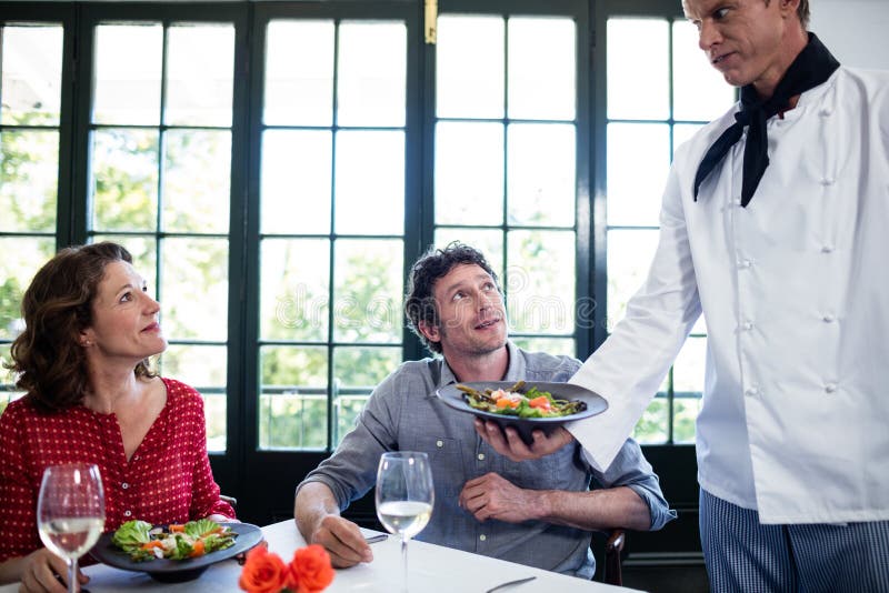 Chef Serving Meal To a Couple Stock Image - Image of attractive ...