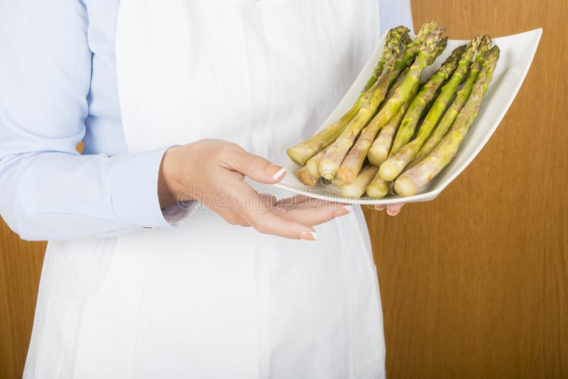 A Chef Showing a Tray with Asparagus Stock Photo - Image of table ...