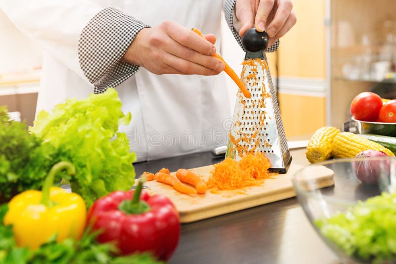 Chef Shredding Carrots with Grater Stock Photo - Image of orange ...