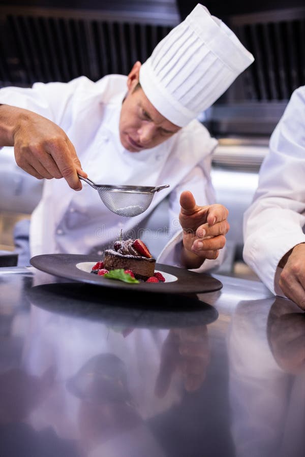 Chef Sieving Icing Sugar Over a Dessert Stock Photo - Image of ...