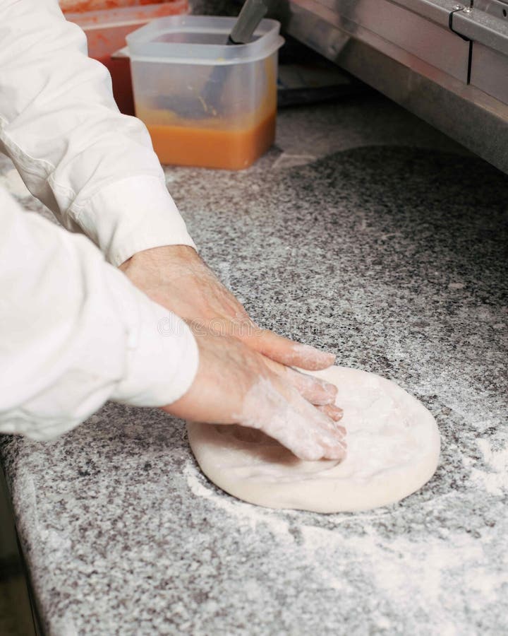 Chef is Skillfully Making Pizza Dough on a Marble Kitchen Countertop ...
