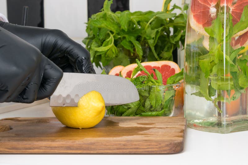 The Chef Slices a Lemon with a Knife for Fruit Drinks Stock Image ...