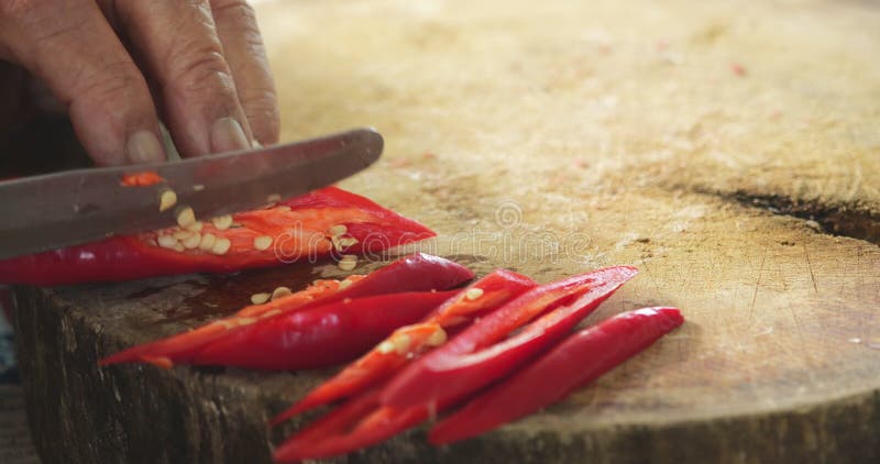 Chef Slices the Red Chilli Pepper. Cutting of Red Chilli Pepper Stock ...