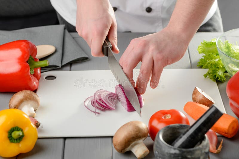 Chef slicing a red onion stock photo. Image of chop - 143611682