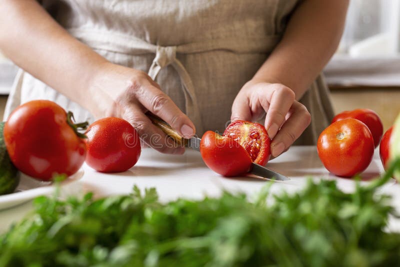 Chef Slicing Tomato Using Knife on the Table in Restaurant. Process of ...