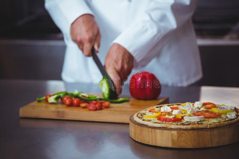 Chef slicing vegetables stock image. Image of restaurant - 68241361