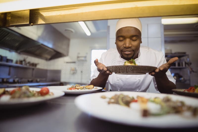 Chef Smelling Food in Commercial Kitchen Stock Image - Image of happy ...