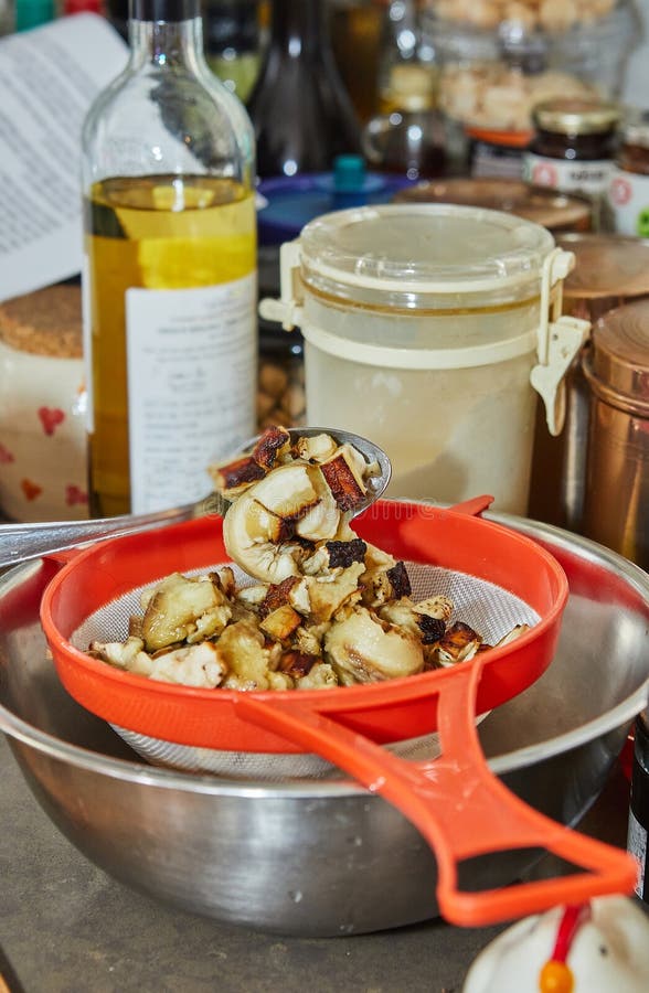 Chef Spoons the Pulp from an Oven-roasted Eggplant into Sieve Stock ...