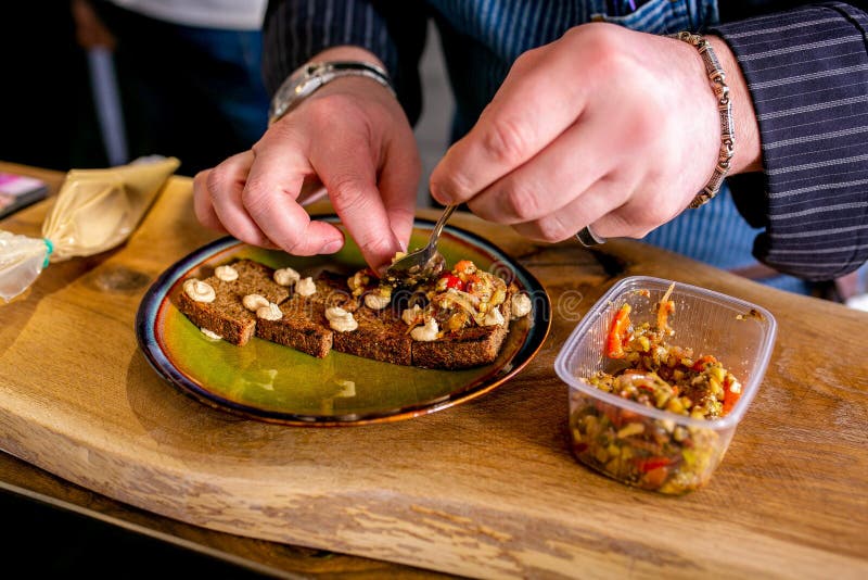 Chef Spreads Baked Vegetables on Fried Craft Bread. Master Class in the ...
