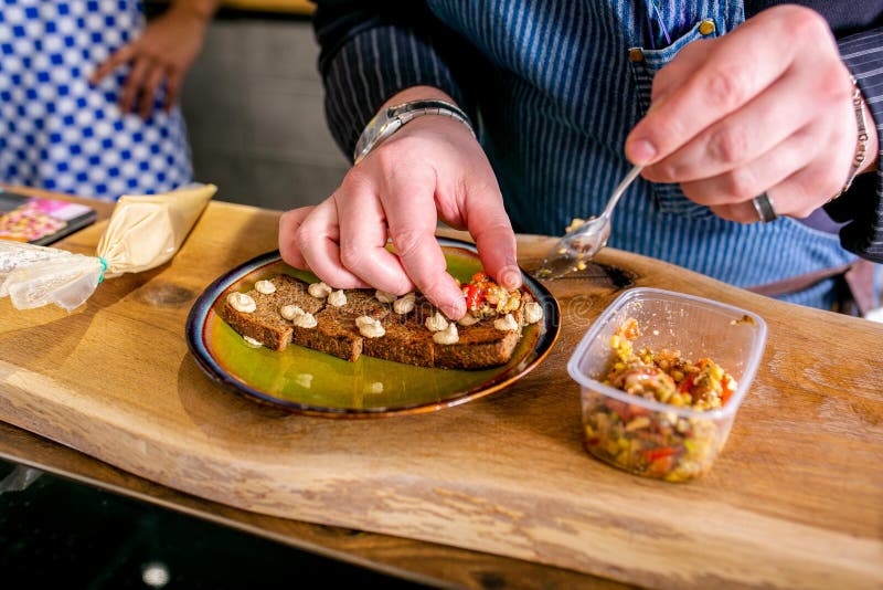 Chef Spreads Baked Vegetables on Fried Craft Bread. Master Class in the ...