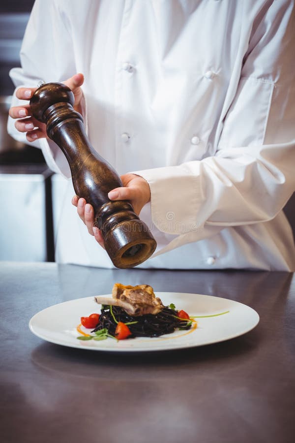 Chef Sprinkling Pepper on Dish Stock Photo - Image of chefs, person ...